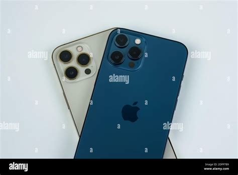 Iphone Pro Max Pacific Blue Next To Iphone Pro Max In Gold Stock Photo Alamy