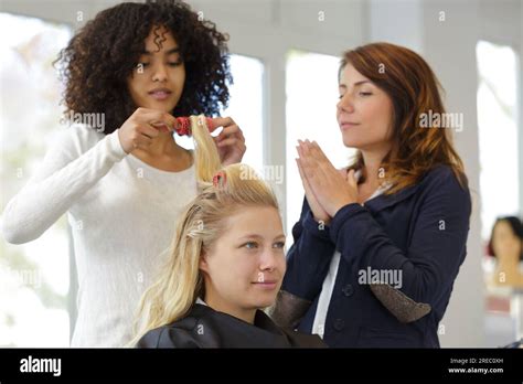 Trainee Hairdresser Practicing Using Curlers Stock Photo Alamy
