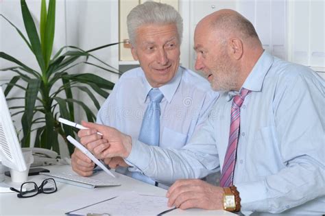 Two Old Business Men Sitting At Desk And Working Stock Photo Image Of