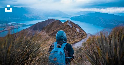 배낭을 멘 사람이 언덕을 오르고 있습니다 사진 Unsplash의 무료 와나카 이미지