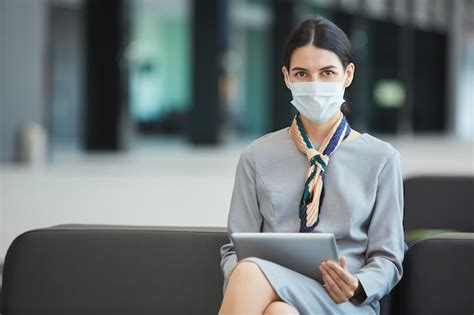 Premium Photo Portrait Of Female Stewardess Wearing Mask And While