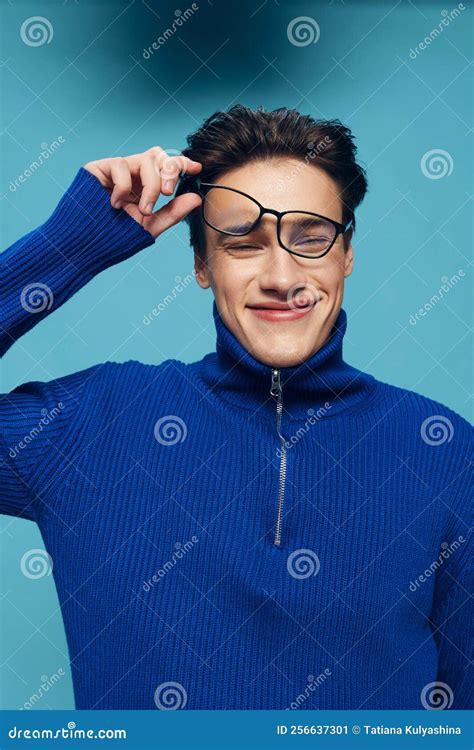 A Handsome Attractive Man Stands On A Light Blue Background In A Blue