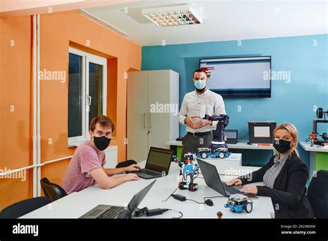 a group of colleagues working together in a robotics laboratory