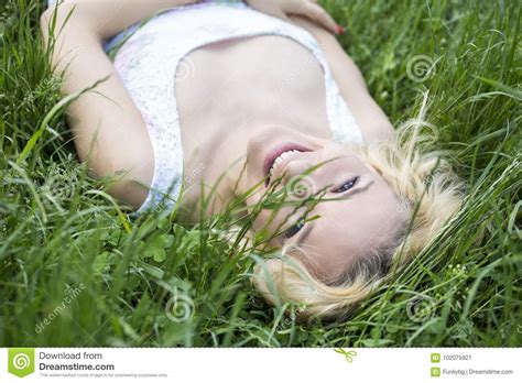 Blue Eyed Blonde Lying On The Grass Stock Image Image Of Colored