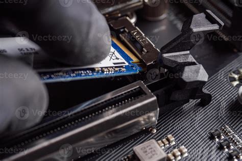 A Specialist Installs A Solid State Drive In The M2 Connector 49146065