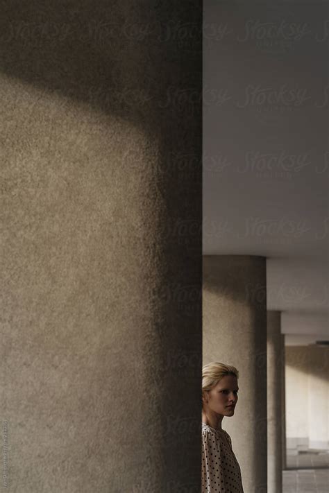 Portrait Of A Girl Between The Columns Of A Building By Stocksy