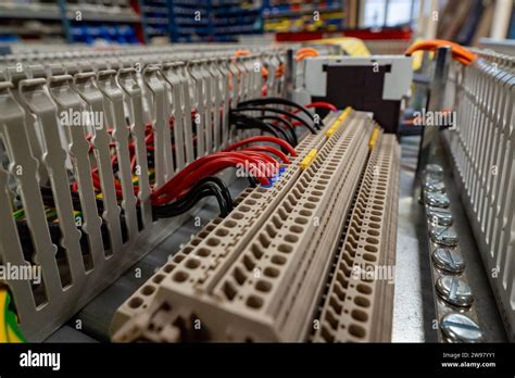 A Factory Assembly Line With An Electronic Cabinet Open Revealing The