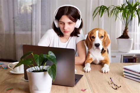 Premium Photo A Young Teenage Girl With Headphones Is Sitting With