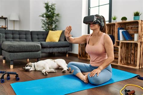 Young Woman Smiling Confident Training Using Vr Goggles At Home Stock