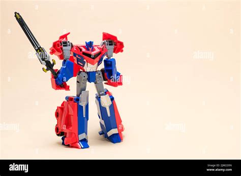 Robot Transformer Red And Blue On A Beige Background With Space For