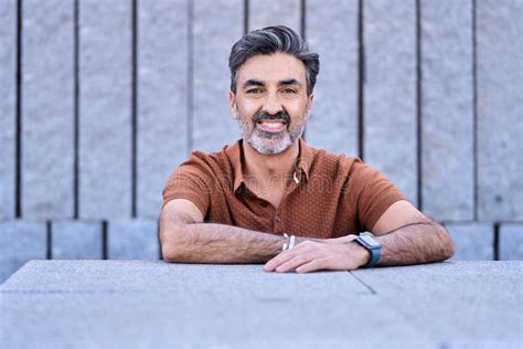 Portrait Of A Middle Aged Man Smiling At Camera Outdoors Stock Photo