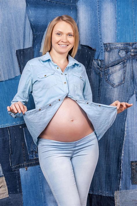 Pregnancy Denim Beautiful Pregnant Woman In Jeans Clothes Posing While Standing Against Jeans