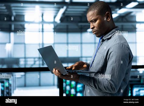 Engineer In Data Center Operating Laptop Deploying New Server Architectures Configuring