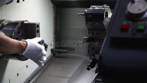 CNC Lathe Operator The Workpiece In The Chuck Is Being Removed Stock