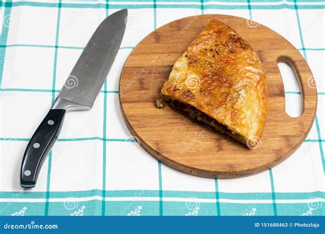 Traditional Burek Pie With Meat Sliced On The Wooden Cutting Board