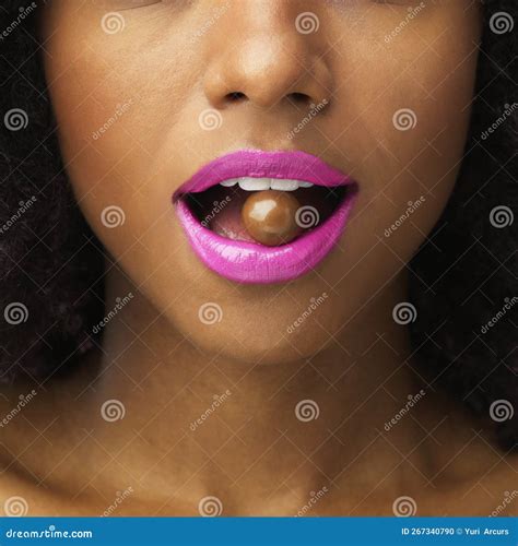Bite Into Goodness An Unrecognizable Woman Posing With A Chocolate