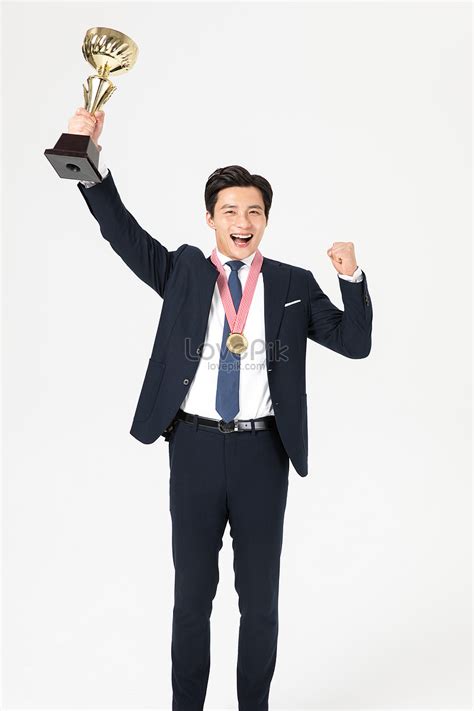 Business Young Man Holding Up A Trophy Picture And Hd Photos Free