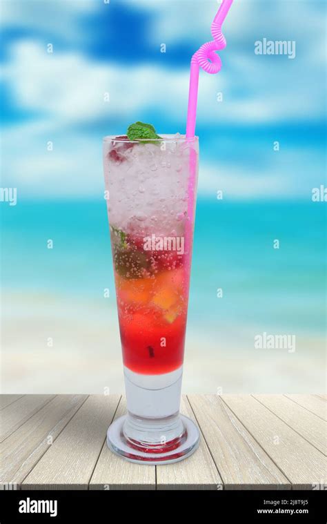 Raspberry Cocktail Fizz Lemonade Ice Tea With Fresh Mint On A Beach