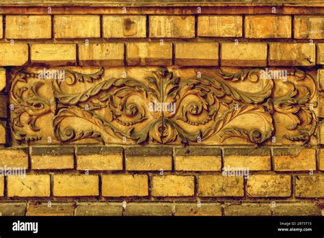 Vintage Facade Decoration Made Of Concrete Molding On Rustic Brick Wall As Retro Background
