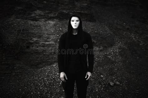 Portrait Of Man In Black Hoodie Wearing White Anonymous Mask Stock