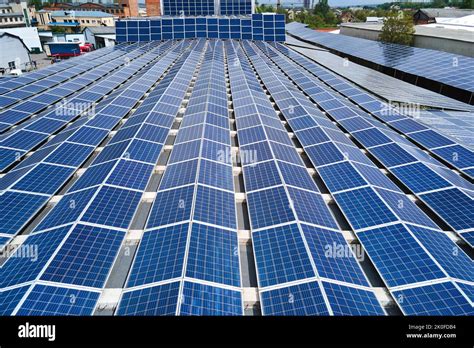 Aerial View Of Blue Photovoltaic Solar Panels Mounted On Industrial