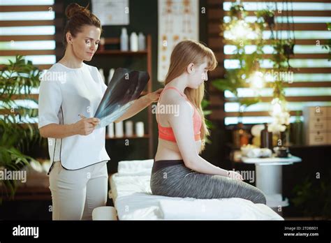 Healthcare Time Concerned Female Massage Therapist In Massage Cabinet
