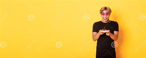 Excited Handsome Asian Guy In Party Glasses Looking Hopeful At