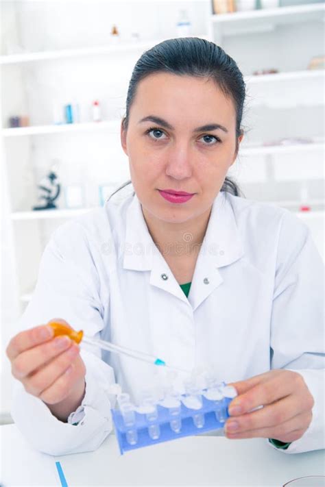 Young Female Scientist Analyzing Sample In Laboratory Laboratory Assistant Analyzing A Sample