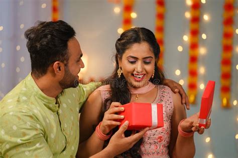 Happy Husband Giving Diwali T Or Present To Wife At Home During