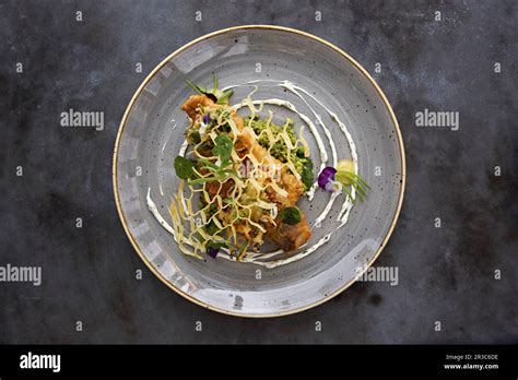A Fine Dining Dish Of Fried Fish Crushed Peas And Potato Lattice Stock