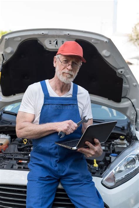 Mechanic Using Laptop for Checking Car Engine Stock Photo - Image of ...