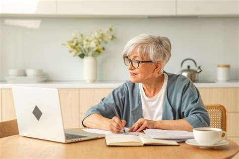 Premium Photo Middle Aged Senior Woman Using Laptop Computer Writing