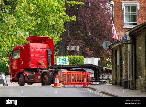 A Giant Red Articulated Lorry Causes Further Disruption At A Junction