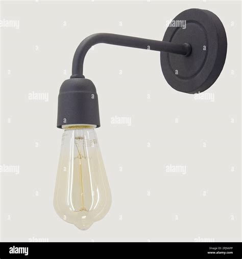 A Light Bulb Is Securely Mounted To An Iron Structure On A Wall Fixture Isolated On A White