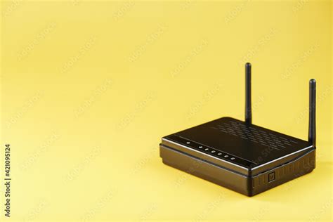 Wi Fi Router In Black On A Yellow Background With Free Space Stock Photo Adobe Stock