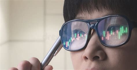 Female Crypto Trader Analyzing Online Trading Stock Market Chart With Reflection On Glasses