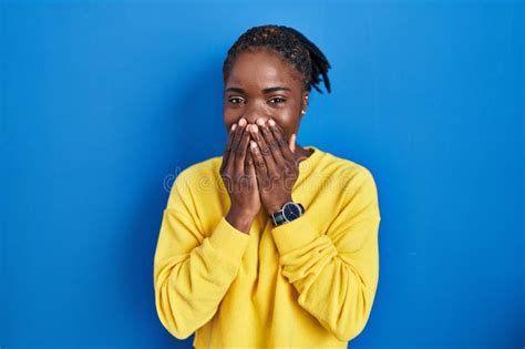 Beautiful Black Woman Standing Over Blue Background Laughing And