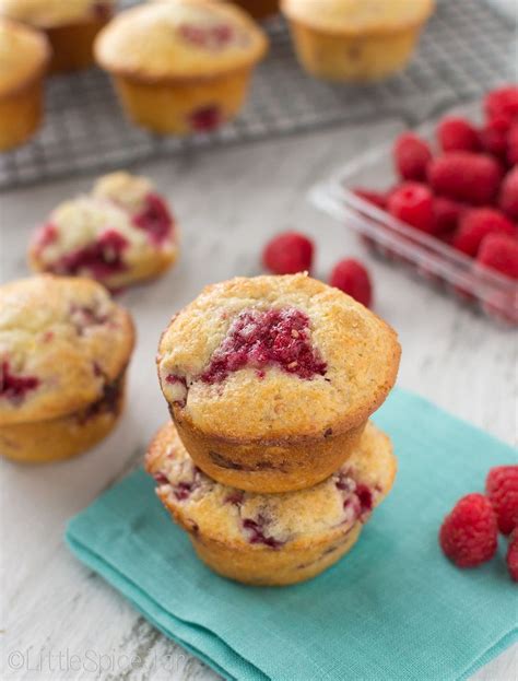 Raspberry Muffins Stacked On Top Of Each Other With Fresh Raspberries