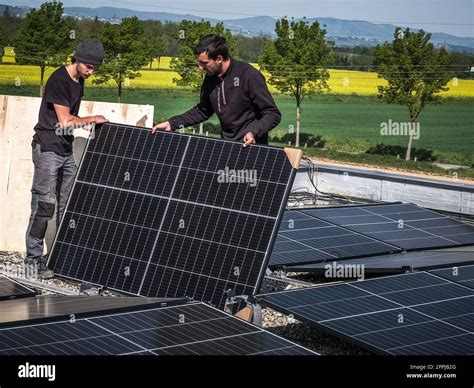 Male Team Engineers Installing Stand Alone Solar Photovoltaic Panel