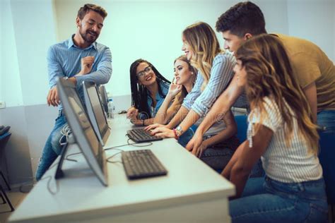 Students Sitting In A Classroom Using Computers During Class Stock