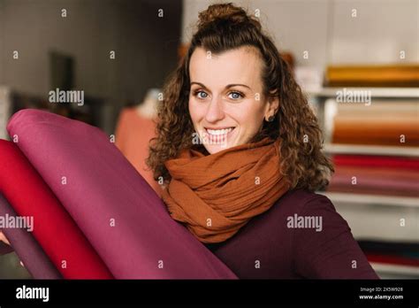 Warm And Inviting Portrait Of A Curly Haired Woman With A Bright Smile