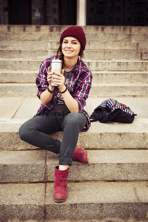 Brunette Woman In Hipster Outfit Sitting On Steps On The Street Toned
