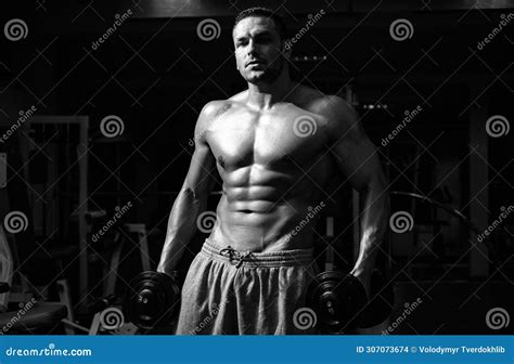 Training In Gym With Dumbbells Sportsman With Naked Torso Sporty