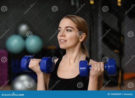 Young Woman Training With Dumbbells In Modern Gym Stock Image Image