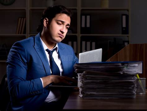 Empleado Joven Que Trabaja Noche En La Oficina Foto De Archivo Imagen