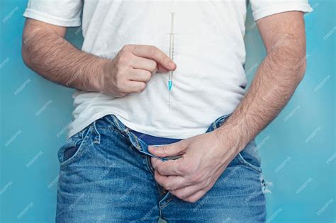 Premium Photo Protection Of Sexually Transmitted Infections A Man Holds A Syringe In His Hands