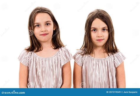 Identical Twin Girls Sisters Are Posing For The Camera Stock Image