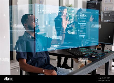 African American Programmer Working With Hologram Checking Data While