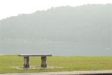 This Picture Presents A Calm And Minimalist Scene Of A Concrete Bench