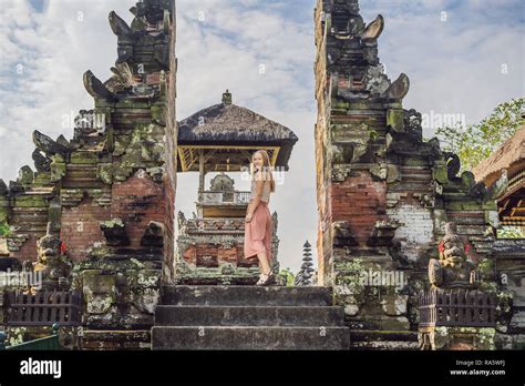 Young Woman Tourist In Traditional Balinese Hindu Temple Taman Ayun In